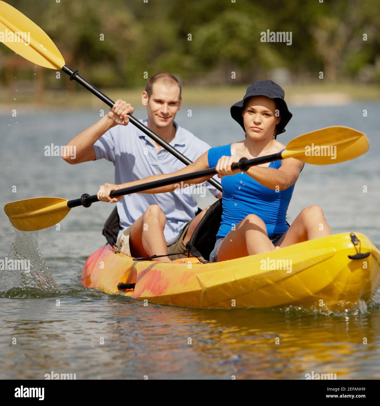 Portrait of a young man and a teenage girl kayaking Stock Photo - Alamy