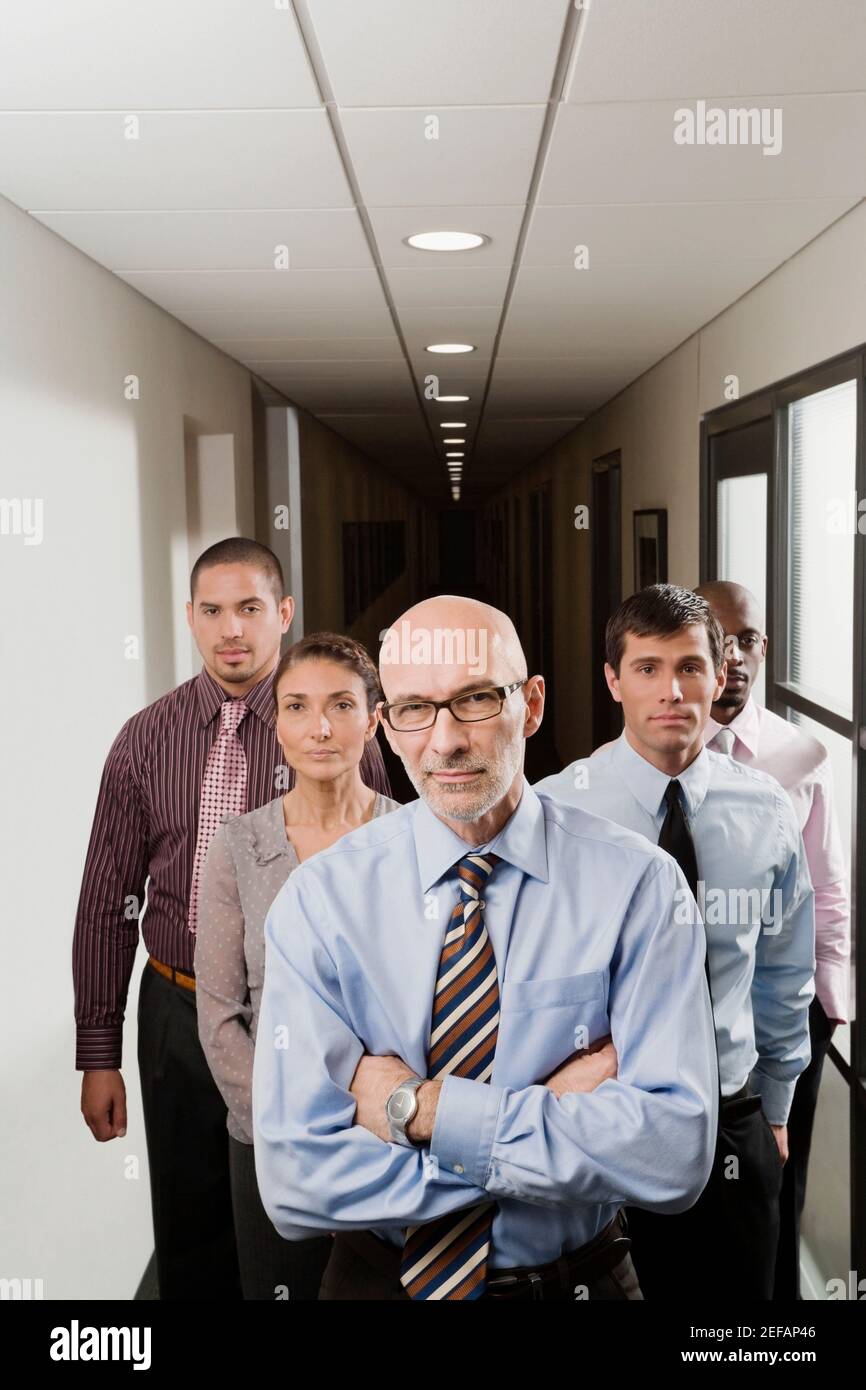 Business executives standing in a corridor Stock Photo - Alamy