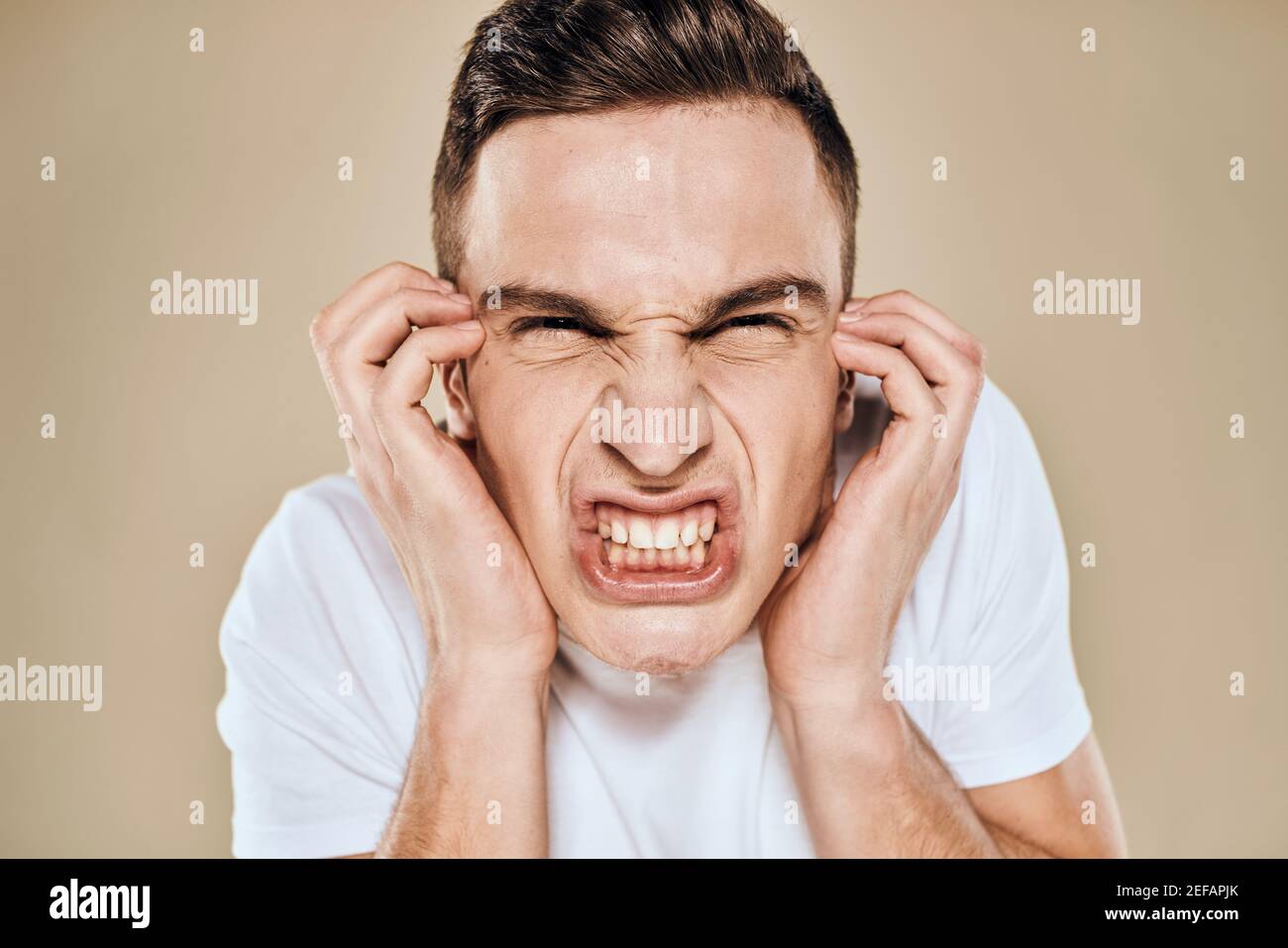 Man with displeased facial expression emotions white t-shirt gestures ...