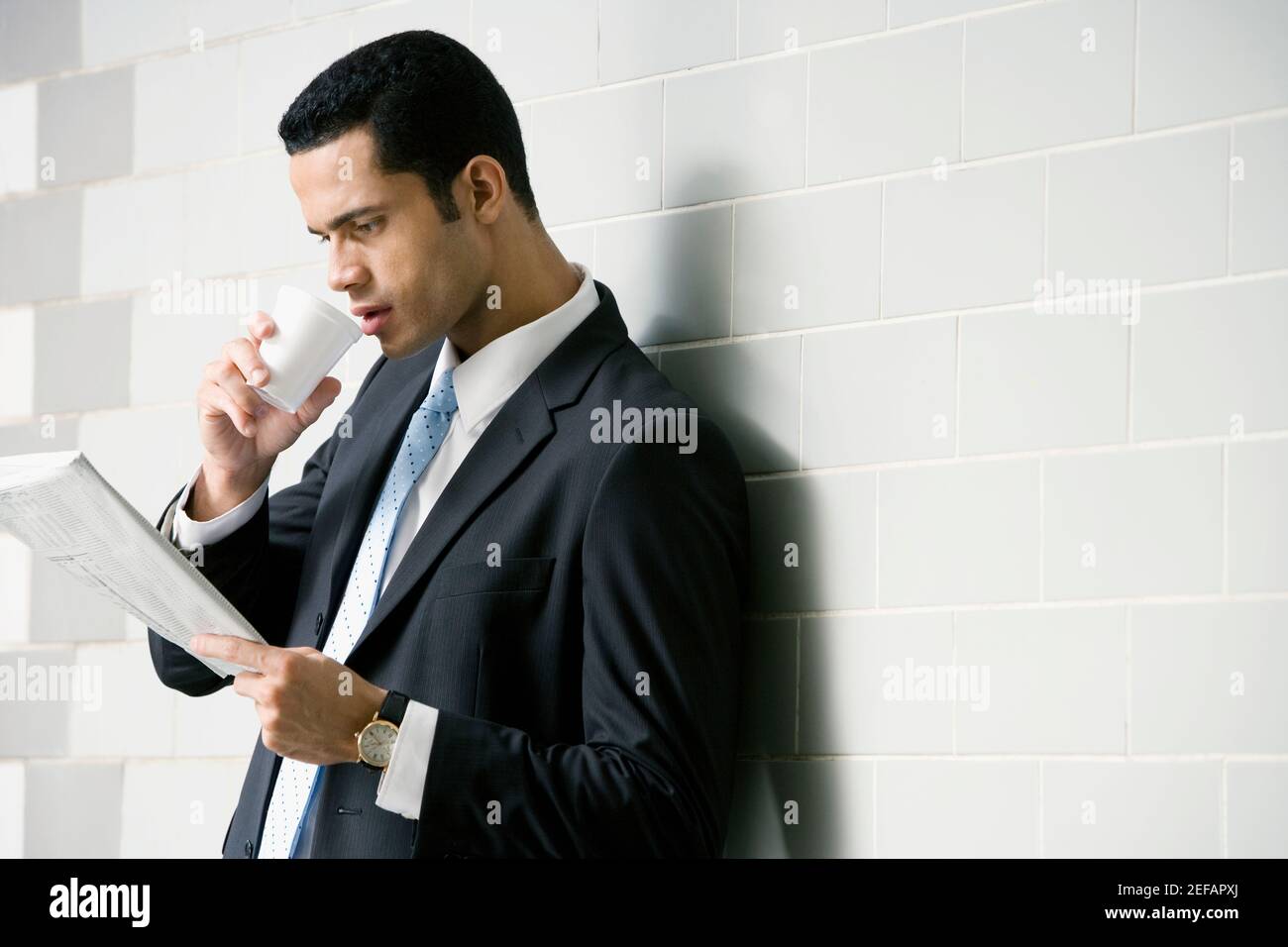 Side profile of a businessman reading a newspaper Stock Photo - Alamy
