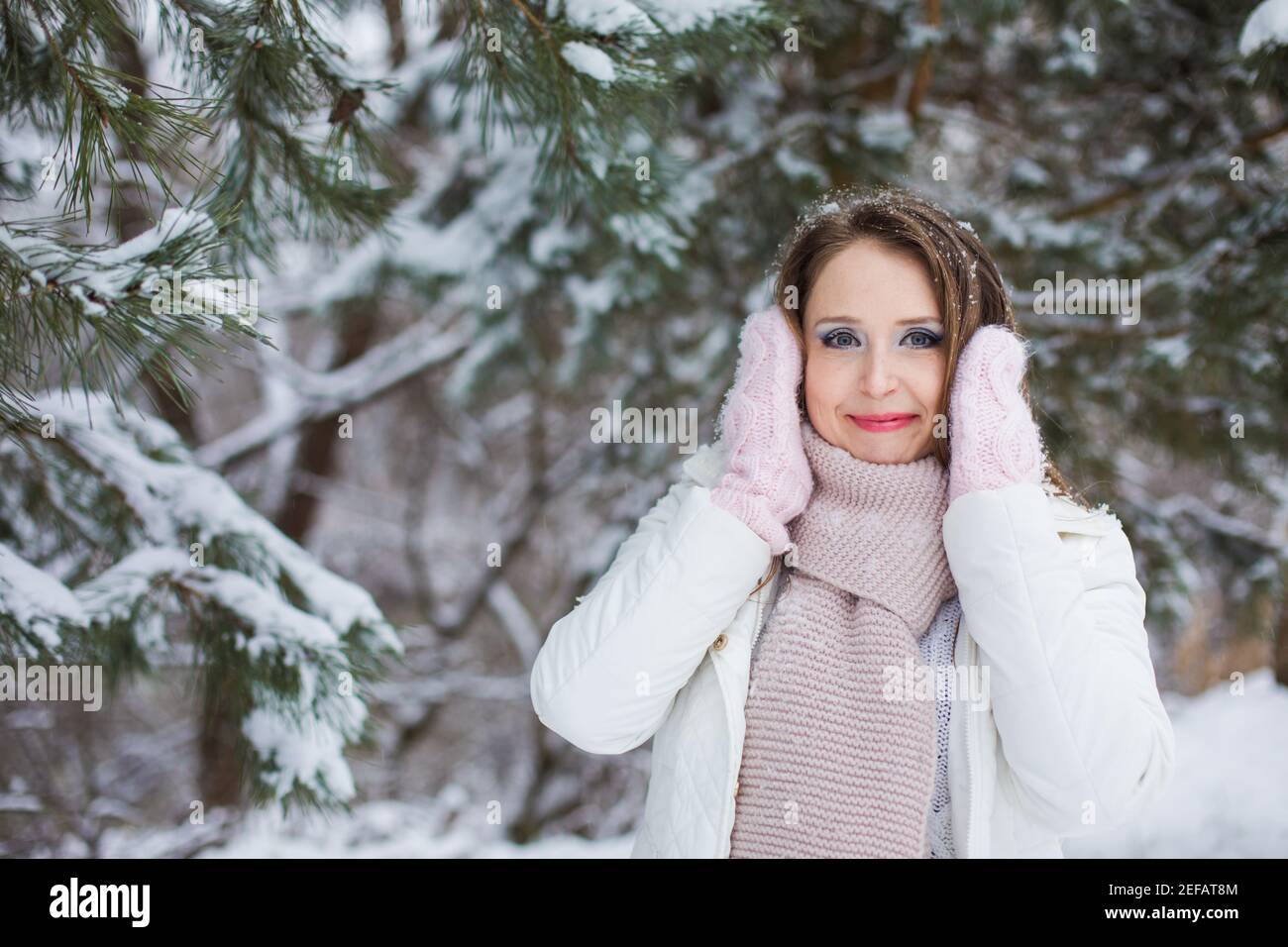 Woman look down and miles under the snow covered tree Stock Photo - Alamy