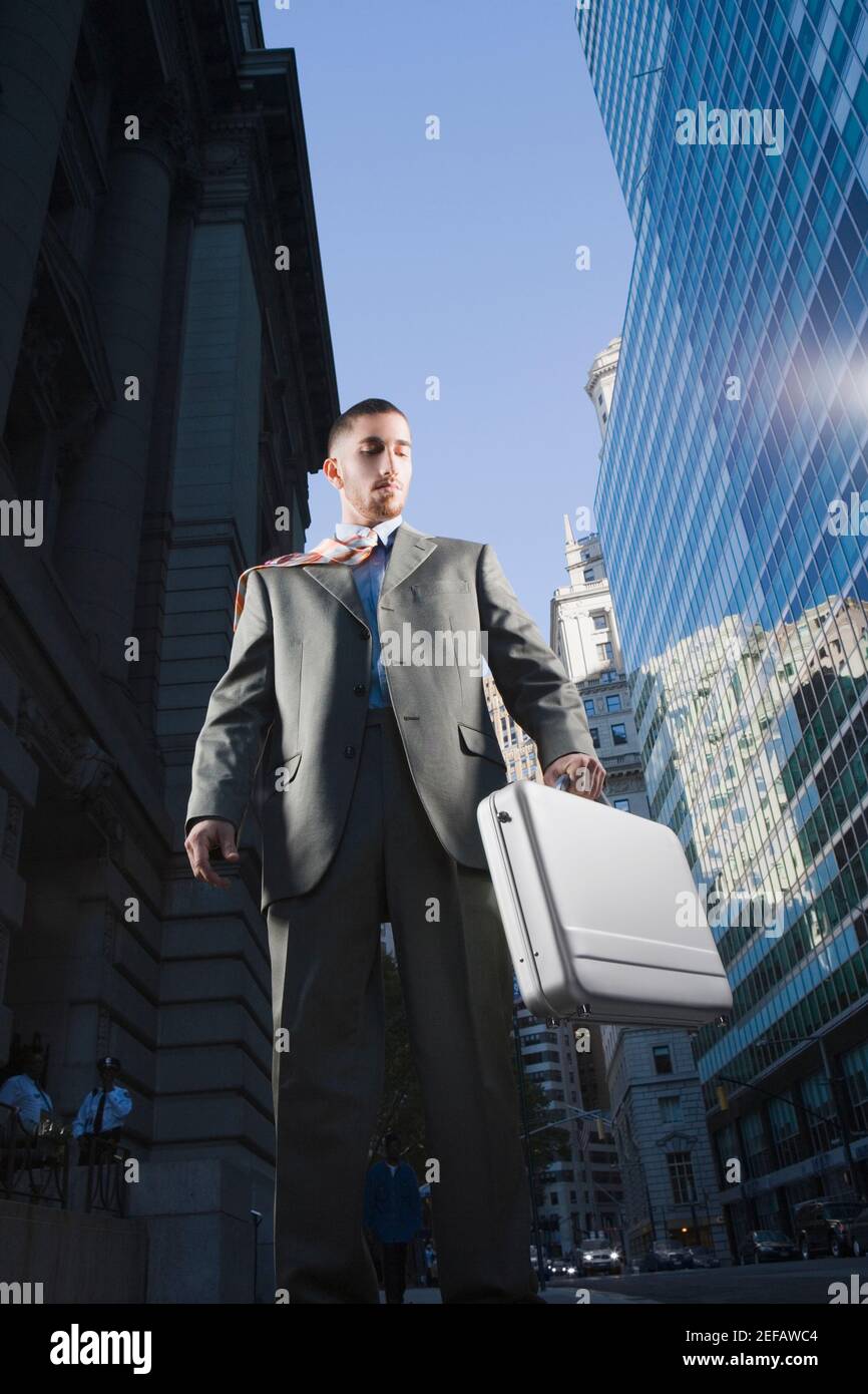 Low angle view of a businessman holding a briefcase Stock Photo - Alamy