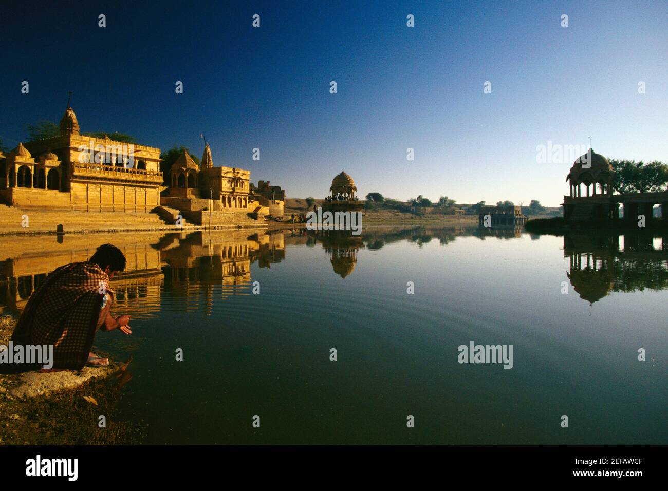 Reflection of a temple in a lake, Gadsisar Lake, Jaisalmer, Rajasthan ...