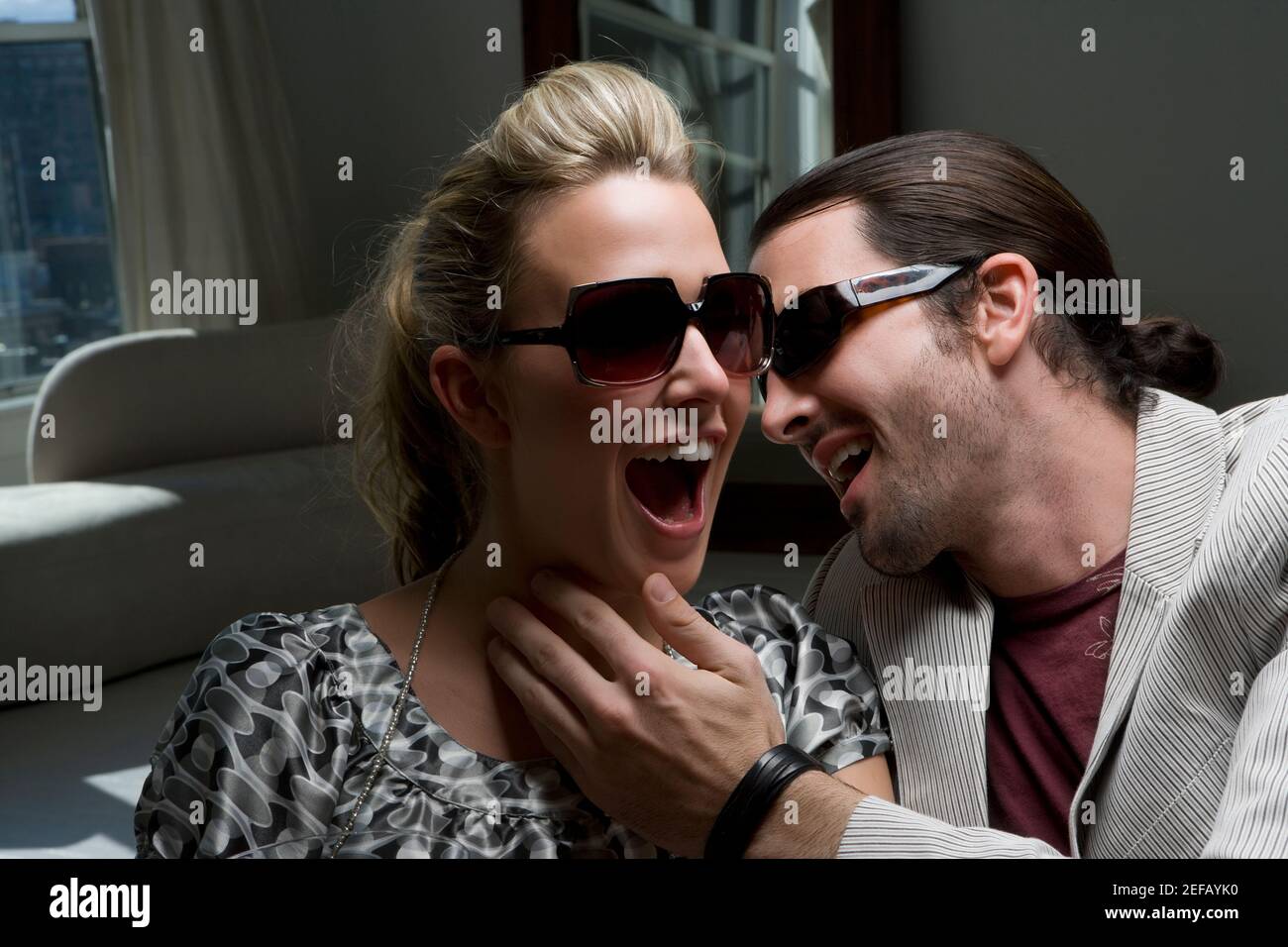 Young couple laughing Stock Photo - Alamy
