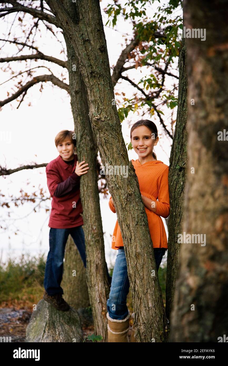 Portrait of two children playing in a forest Stock Photo - Alamy