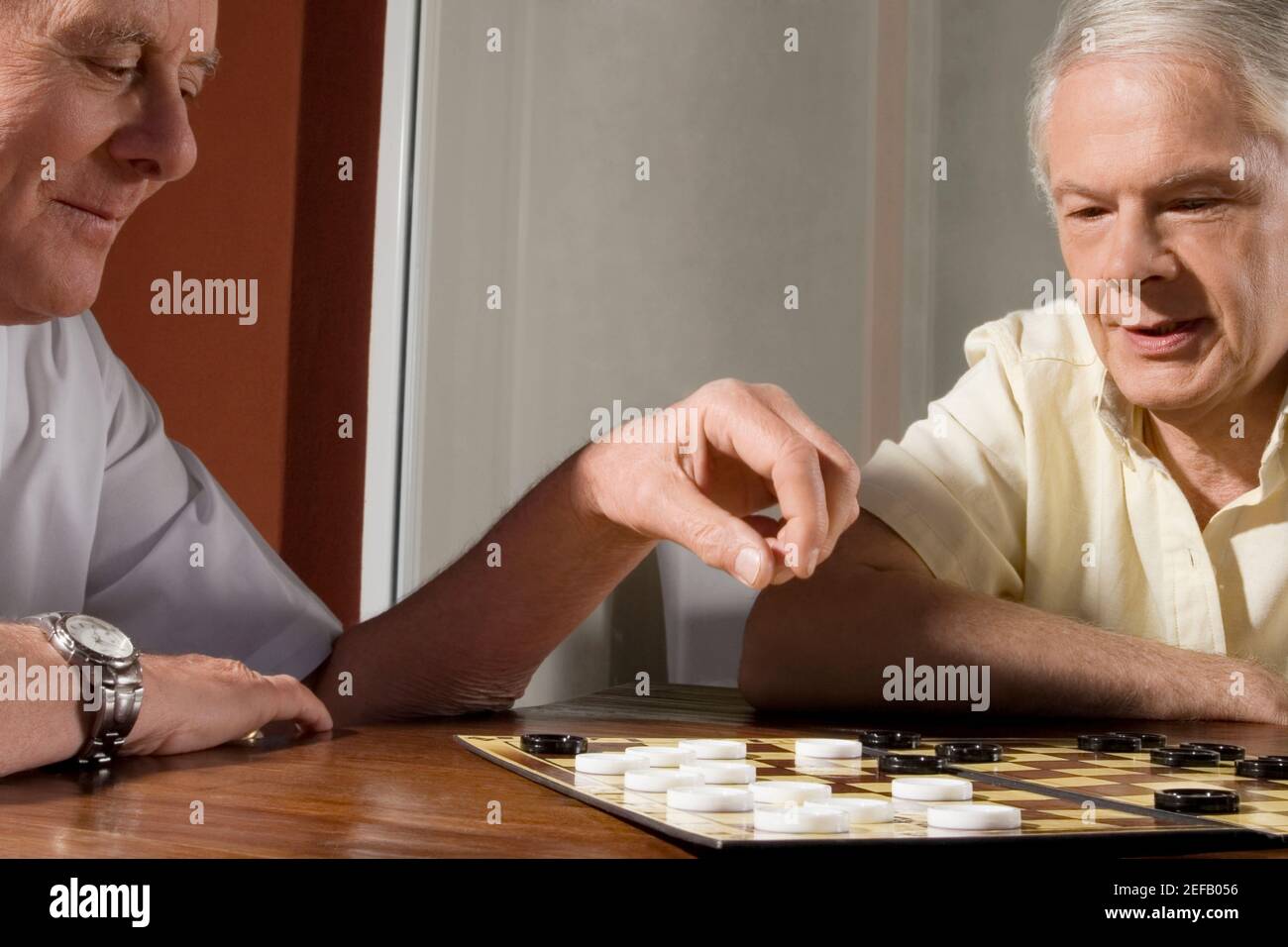 Two senior men playing checkers Stock Photo - Alamy