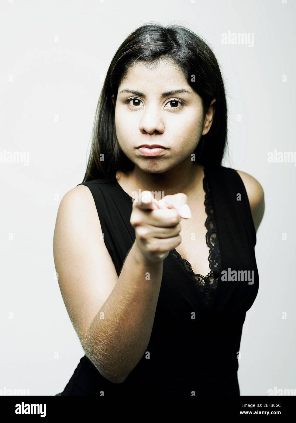 Portrait of a young woman pointing forward Stock Photo - Alamy