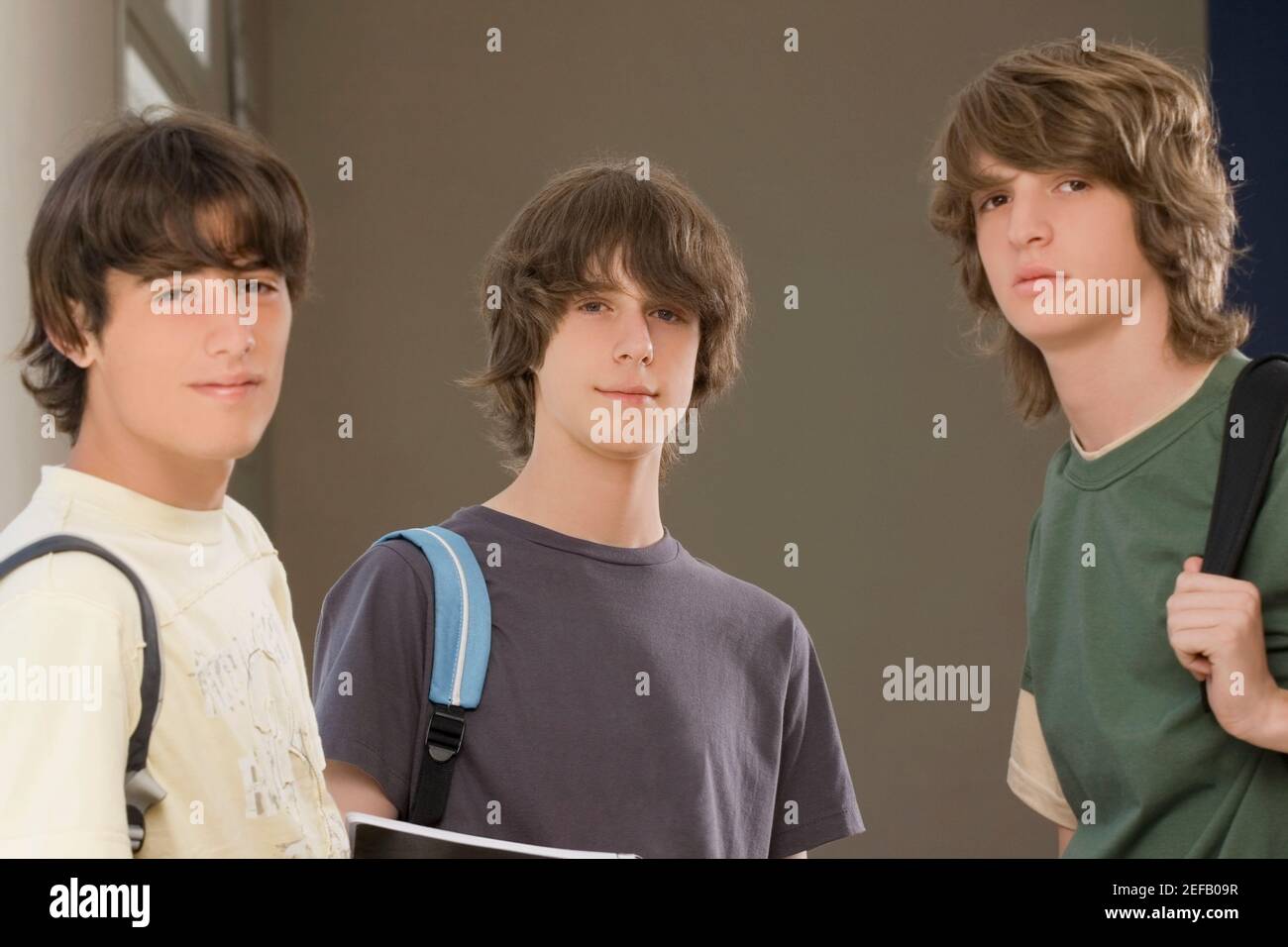 Portrait of two teenage boys standing with a young man Stock Photo - Alamy