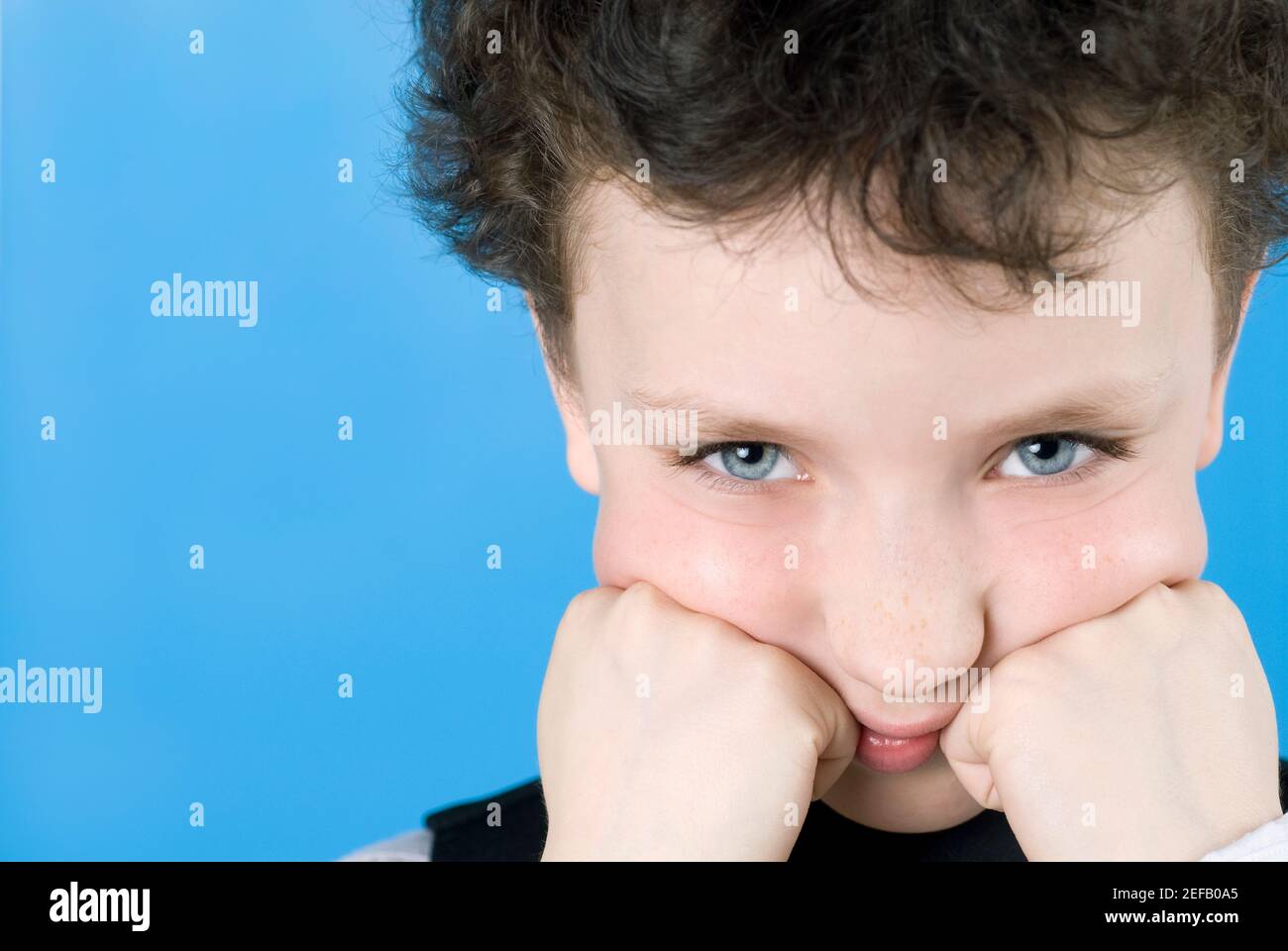 Portrait of a boy with his hands on his cheeks Stock Photo - Alamy