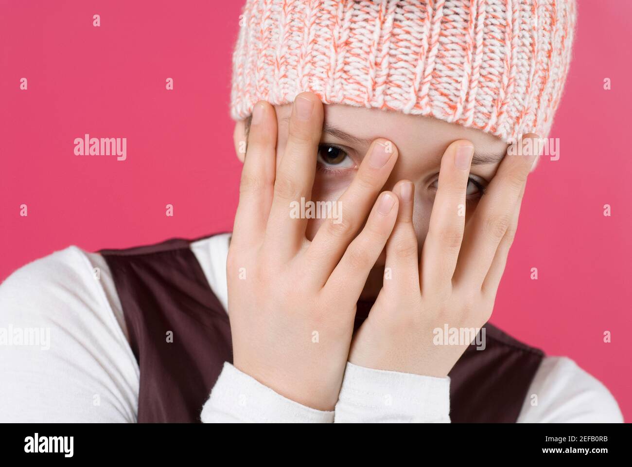 Close up of a girl hiding her face with her hands Stock Photo - Alamy