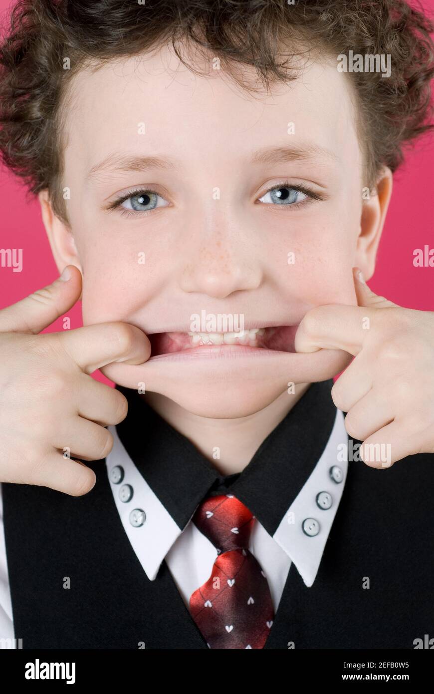 Close up of a boy pulling his lips corners Stock Photo - Alamy