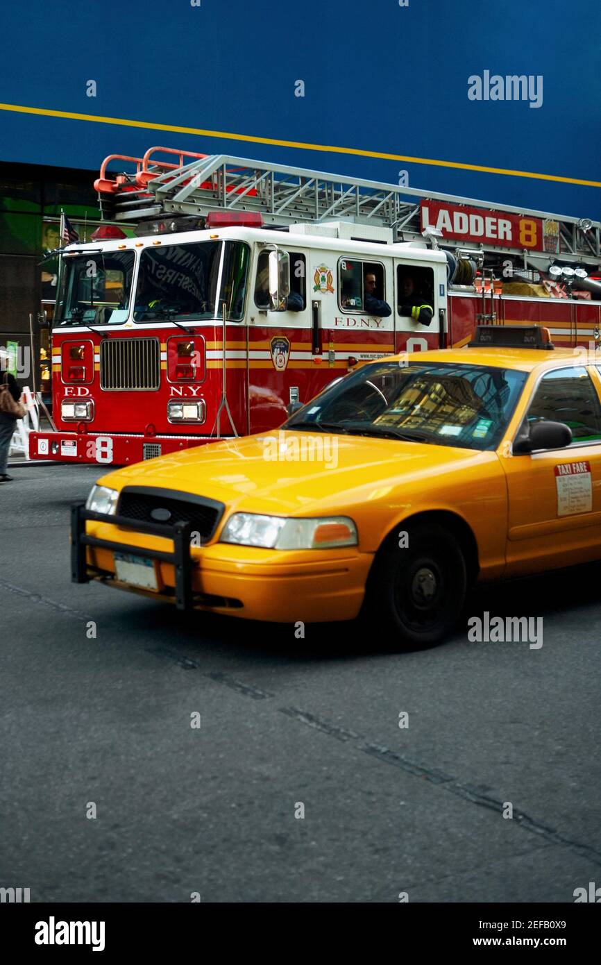 Fire engine and a yellow taxi on a road, New York City, New York State ...