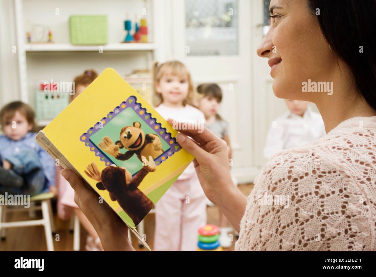 Female teacher teaching her students in a classroom Stock Photo - Alamy