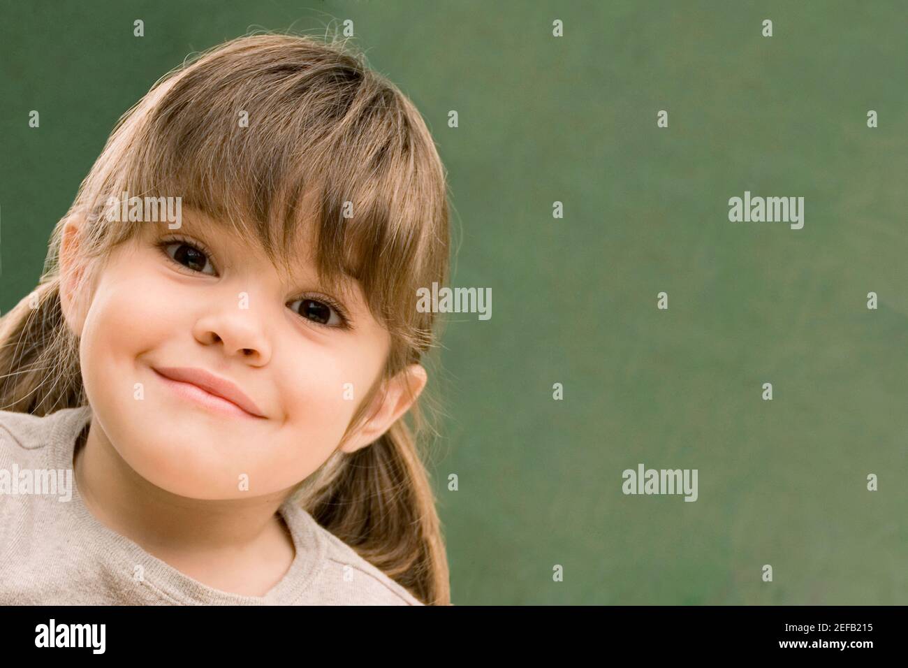 Portrait of a girl smirking Stock Photo - Alamy