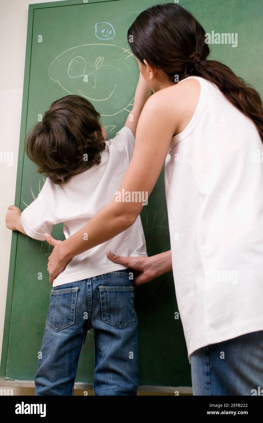 Female teacher teaching her student in a classroom Stock Photo - Alamy