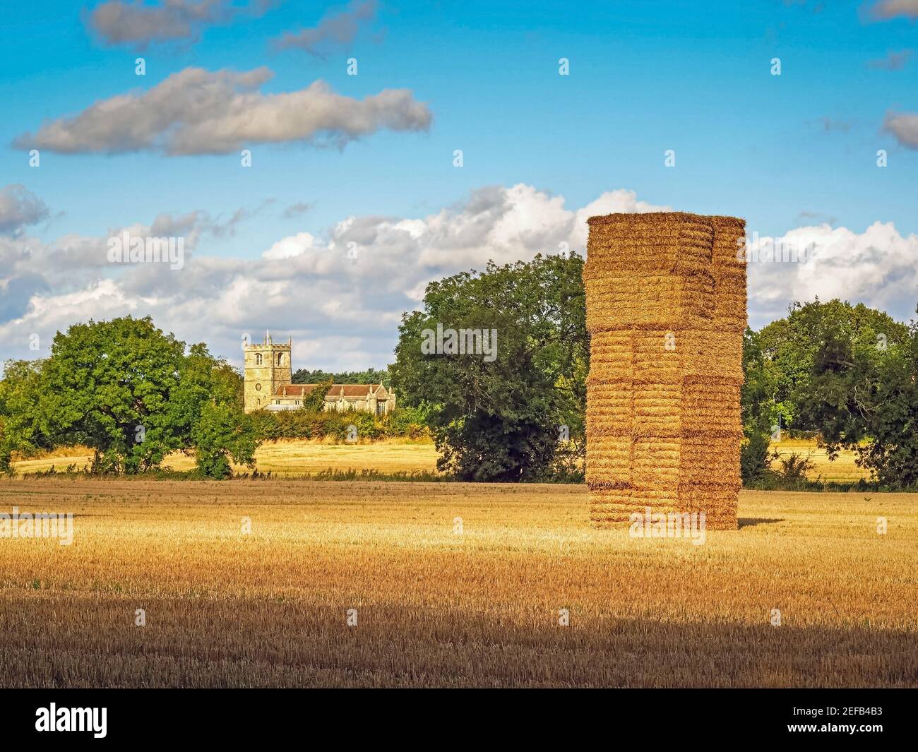 Tall haystack in a field at Skipwith, North Yorkshire, England, with a ...