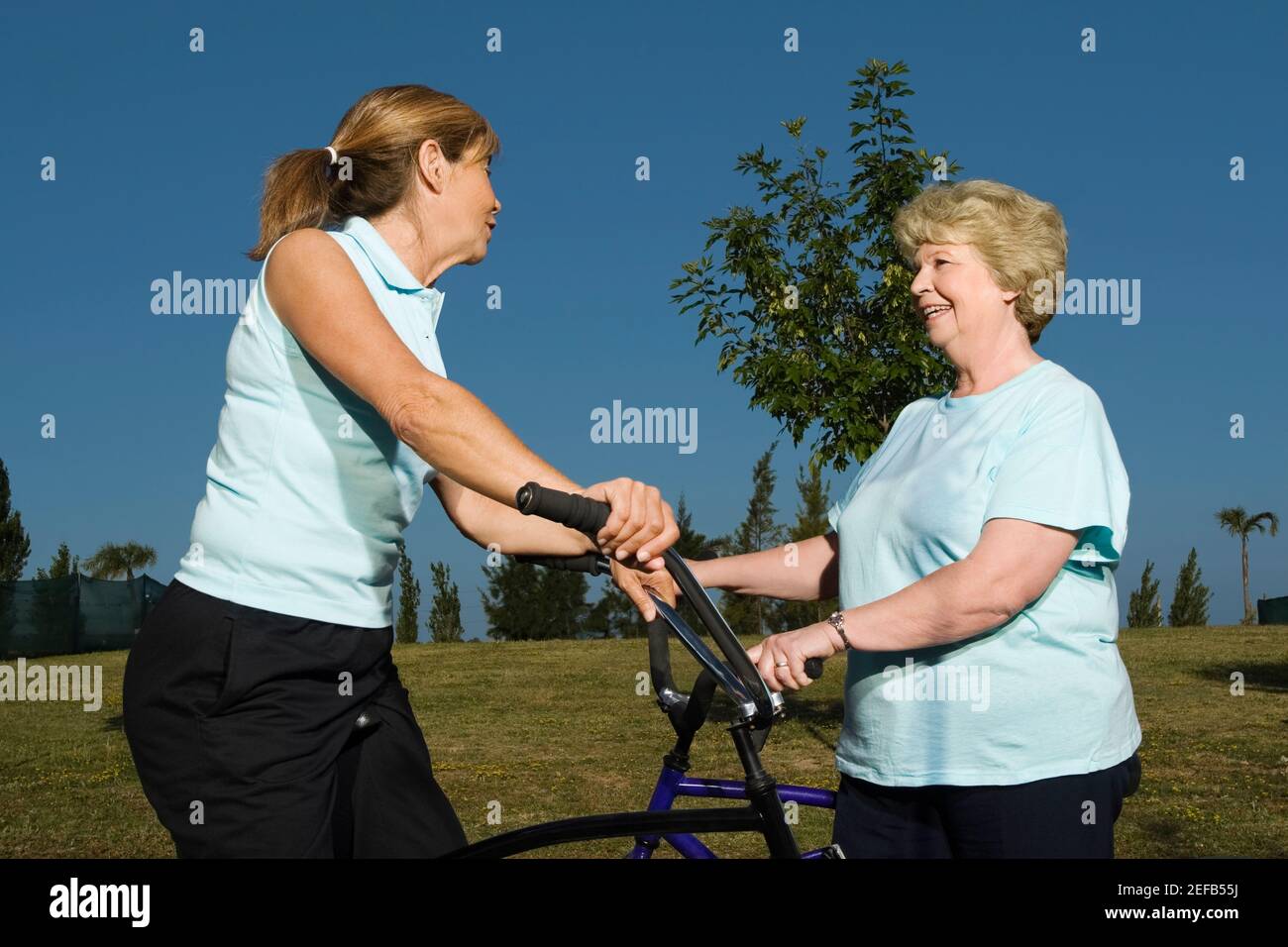Side profile of two senior women talking to each other Stock Photo - Alamy