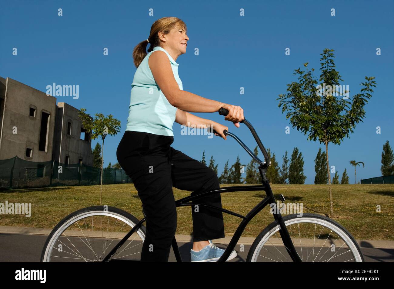 Side profile of a senior woman cycling Stock Photo - Alamy