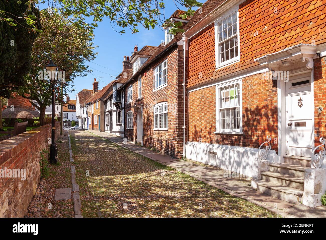 Old timber-framed and brick english houses along cobblestone street in ...