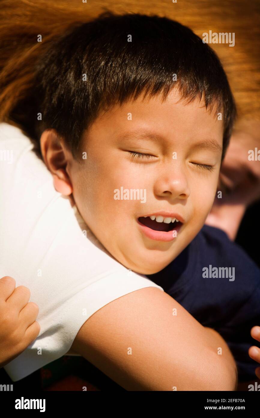 Side profile of a person hugging a boy Stock Photo - Alamy