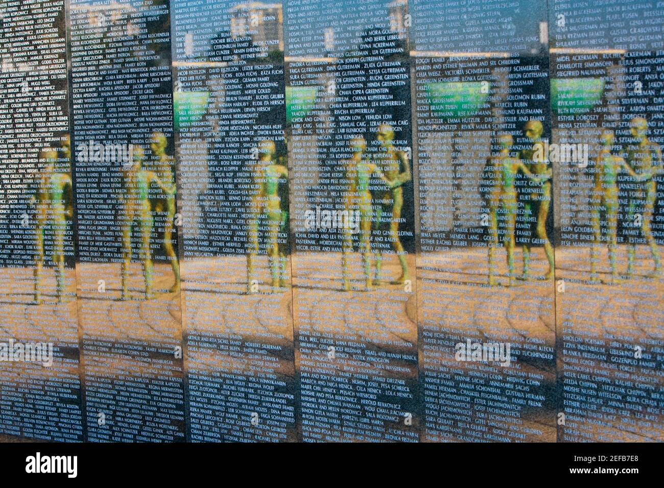 Reflection of statues on a memorial wall Stock Photo - Alamy