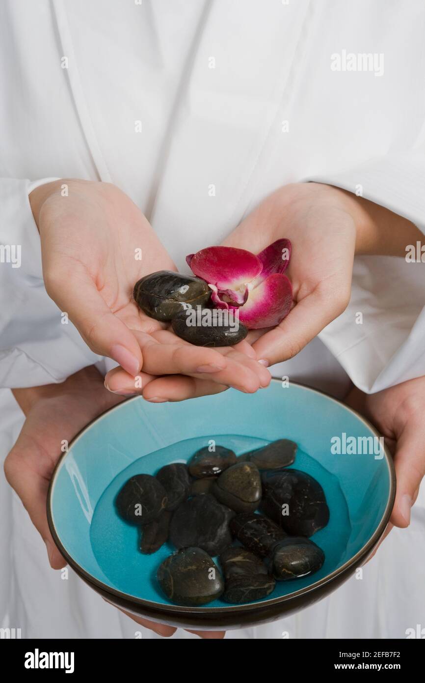 Close up of two people holding pebbles Stock Photo - Alamy