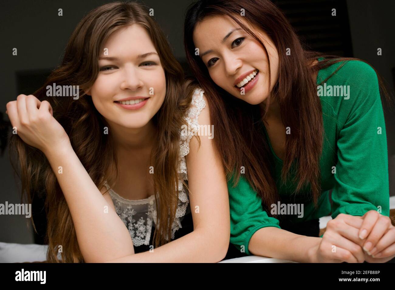 Portrait of two young women smiling Stock Photo - Alamy