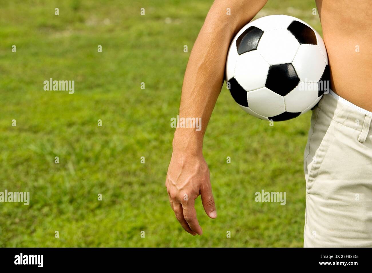 Mid section view of a man holding a soccer ball Stock Photo - Alamy
