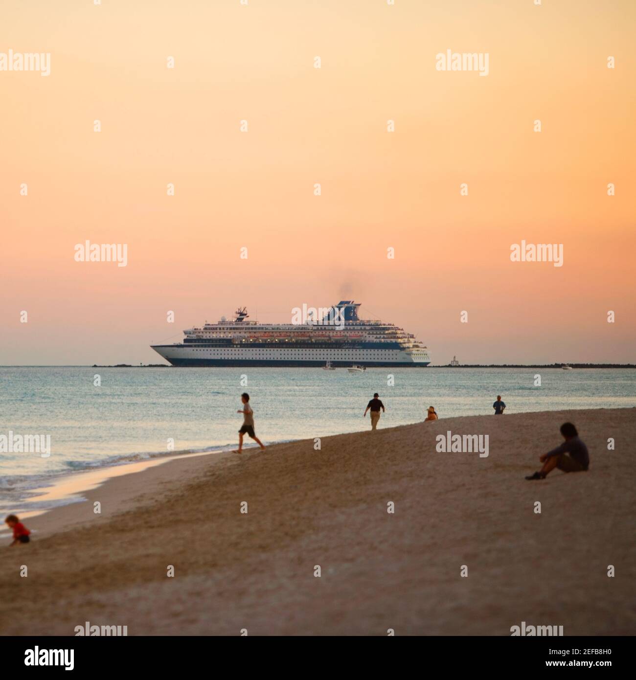 Tourist on the beach at dusk Stock Photo - Alamy