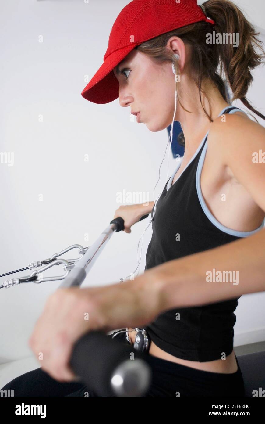 Side profile of a young woman exercising in a gym Stock Photo - Alamy