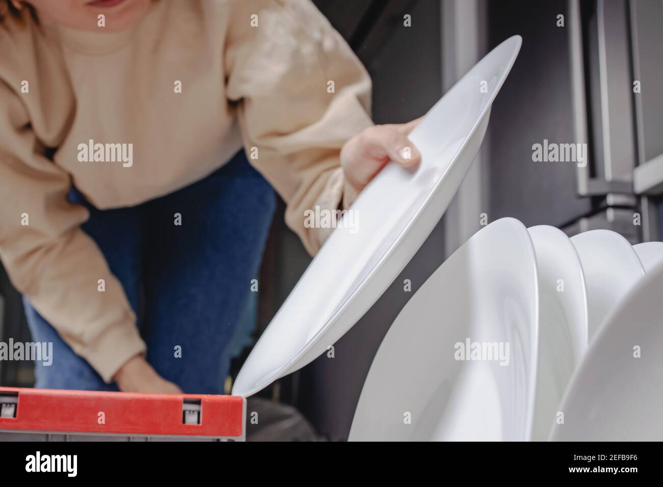 Woman Removing Plate View From Inside The Dishwasher Stock Photo - Alamy