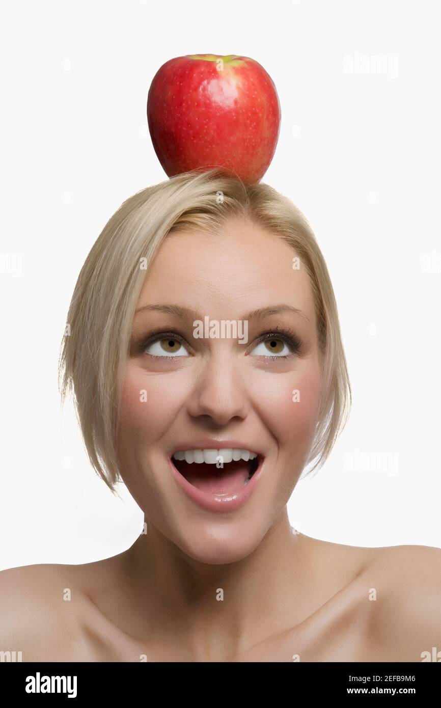 Woman balancing apple on head hi-res stock photography and images - Alamy