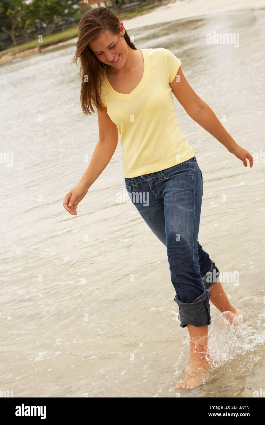 Teenage girl walking in water Stock Photo - Alamy