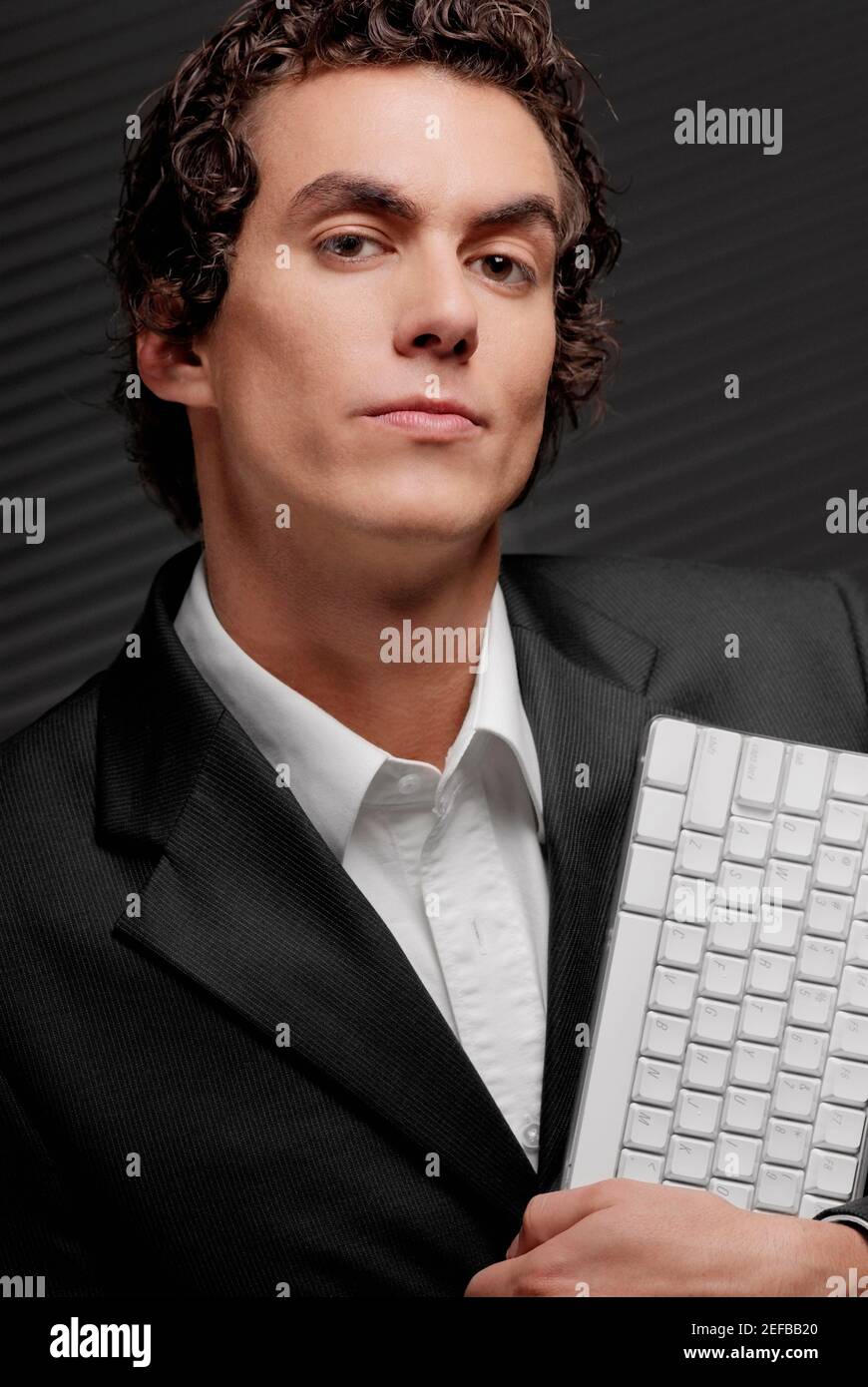 Portrait of a businessman holding a computer keyboard Stock Photo - Alamy