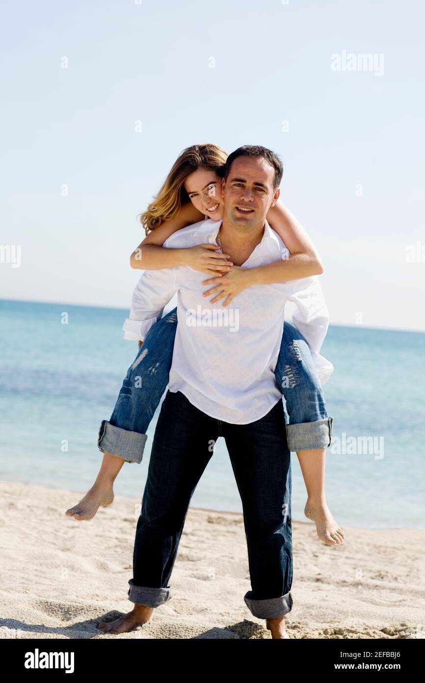 Mid adult man riding piggyback hi-res stock photography and images - Alamy