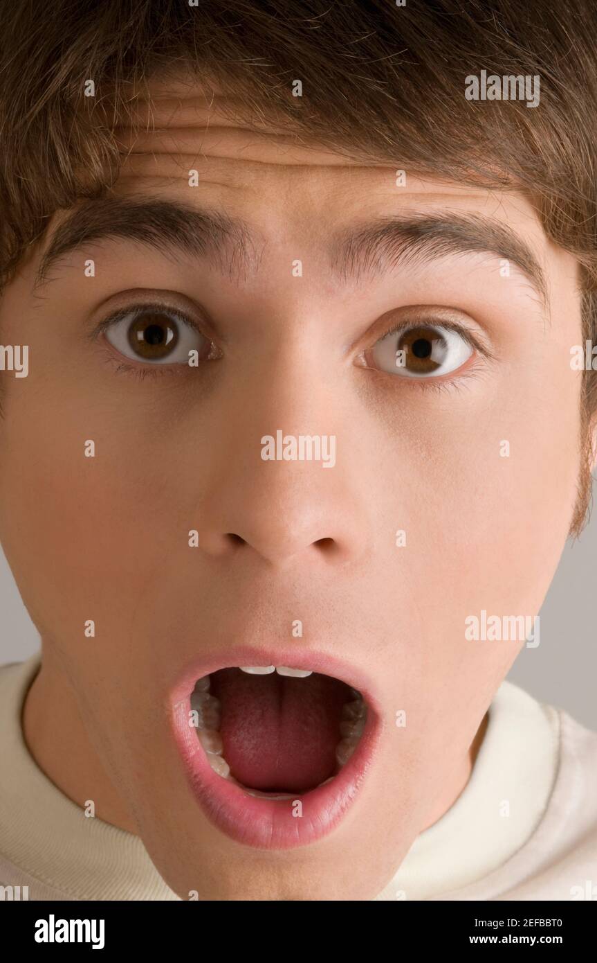 Portrait of a young man looking surprised Stock Photo - Alamy