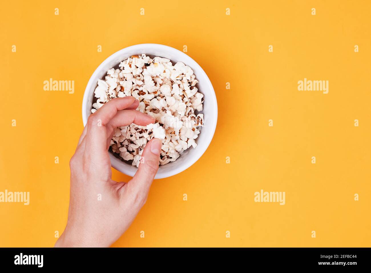 Woman taking delicious popcorn hi-res stock photography and images - Alamy