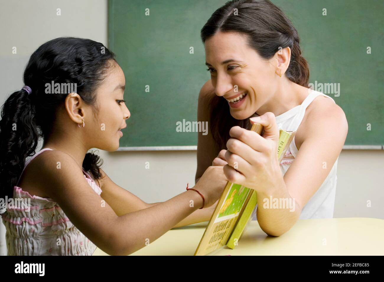 Female teacher teaching her student in a classroom Stock Photo - Alamy