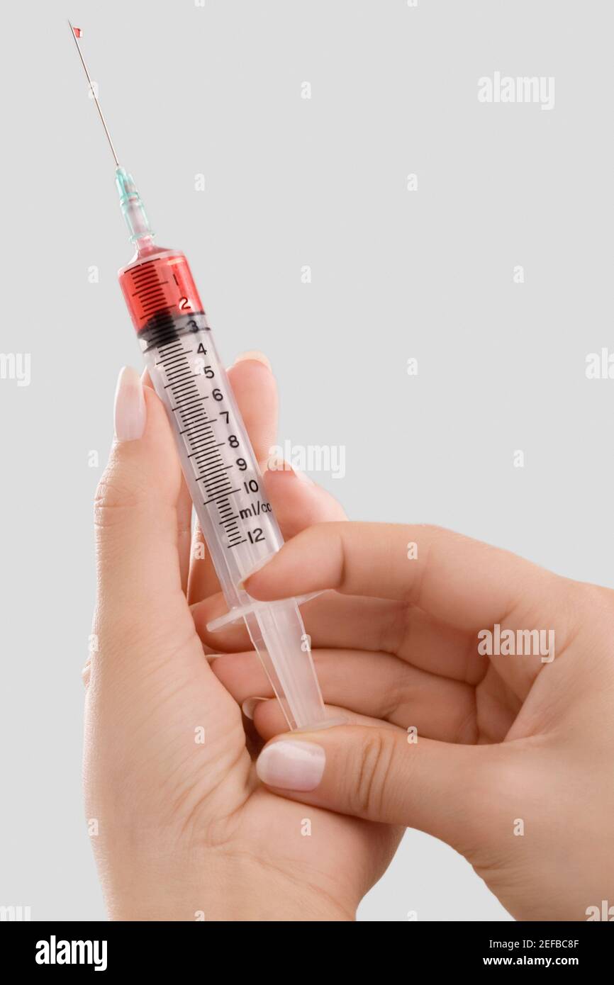 Hand with a syringe hi-res stock photography and images - Alamy