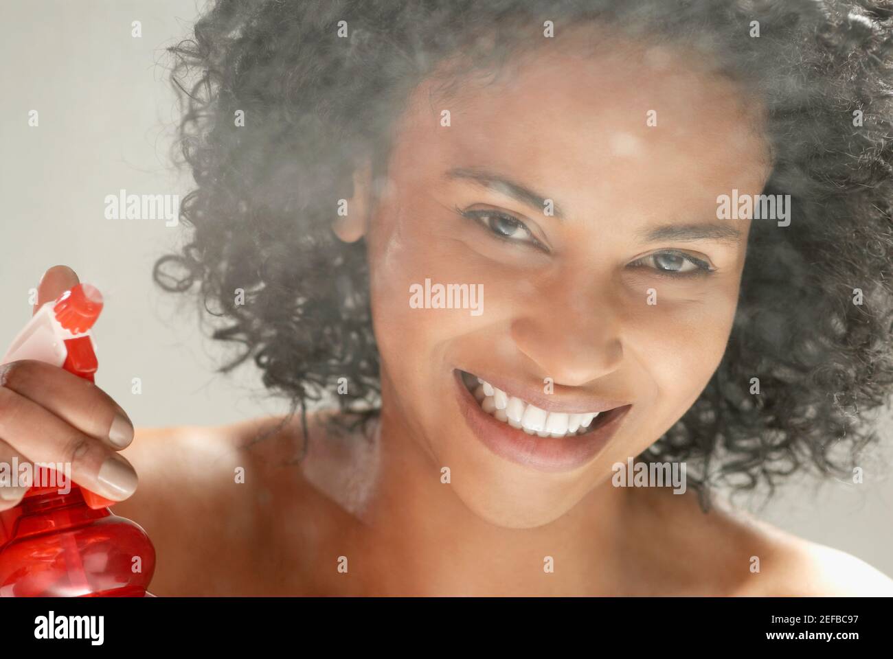 Portrait young woman spraying hi-res stock photography and images - Alamy
