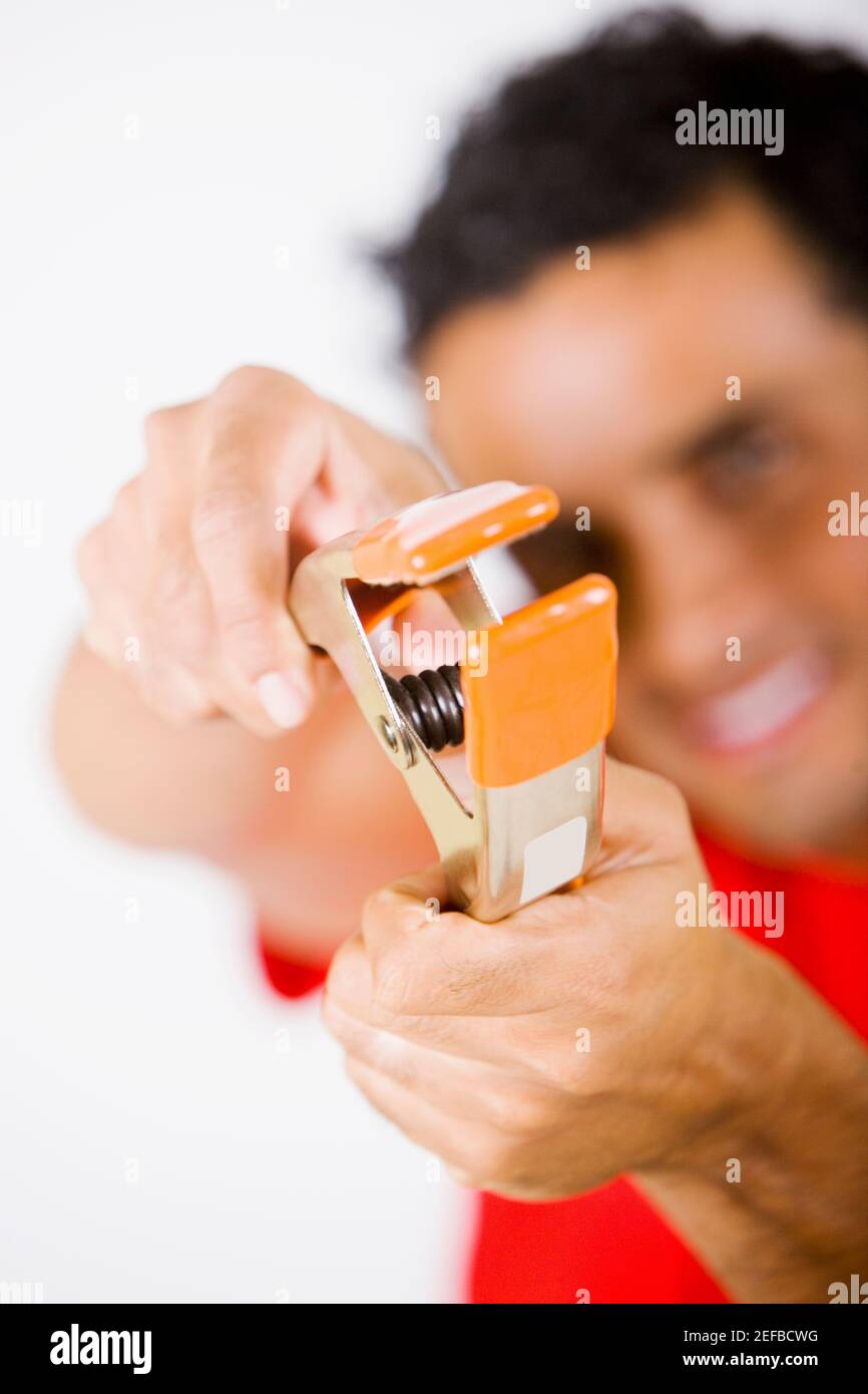 Young man holding a clamp Stock Photo - Alamy