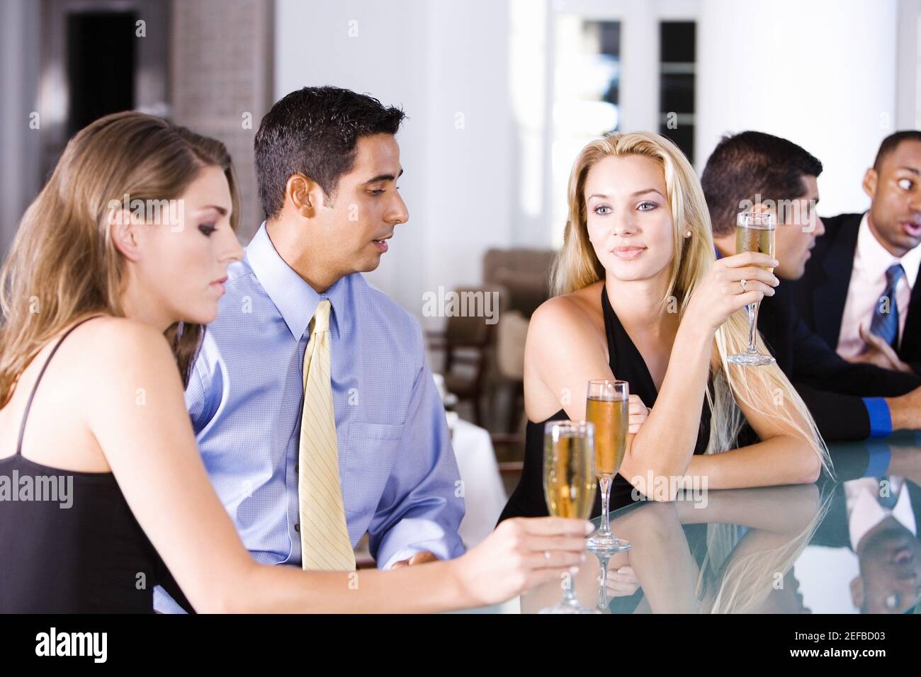 Five people sitting at a bar counter Stock Photo - Alamy