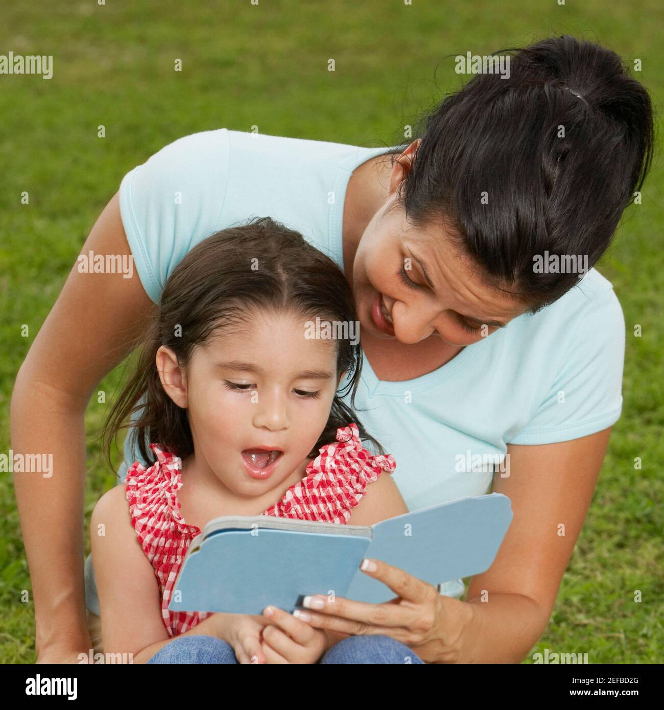 Girl sitting book on lap hi-res stock photography and images - Alamy