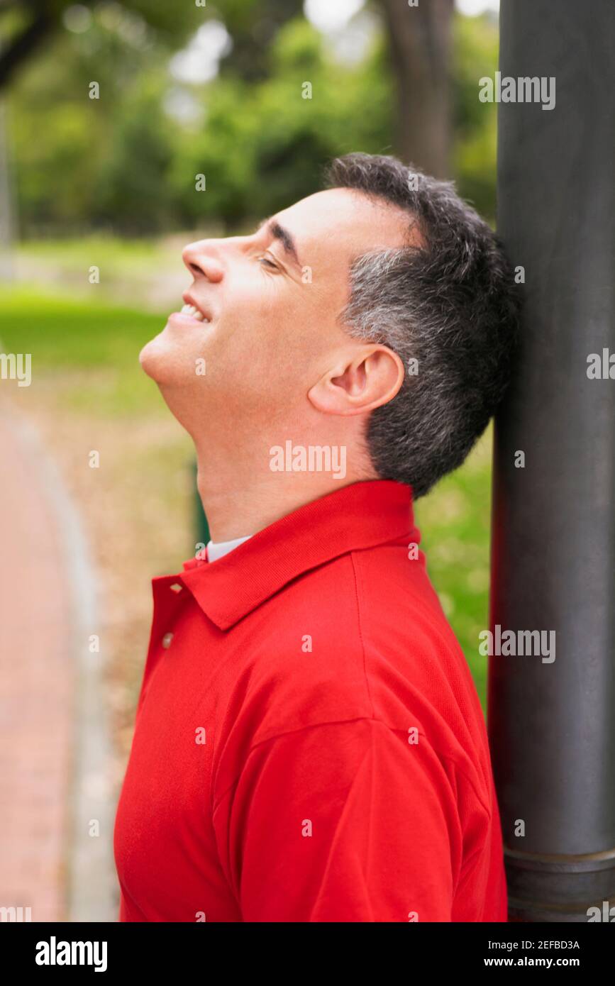 Leaning against a pole hi-res stock photography and images - Alamy