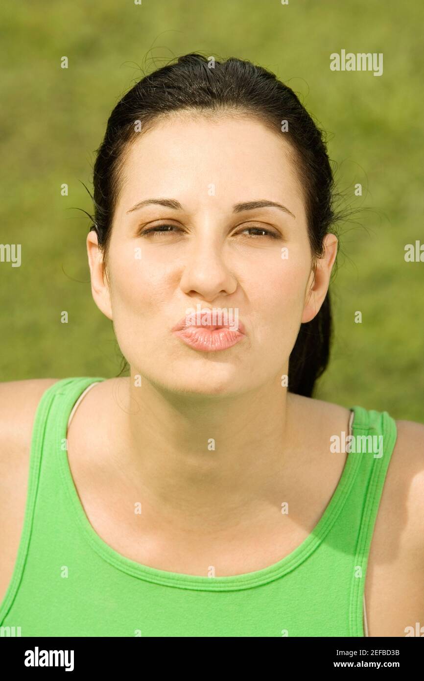 Portrait of a young woman puckering her lips Stock Photo - Alamy