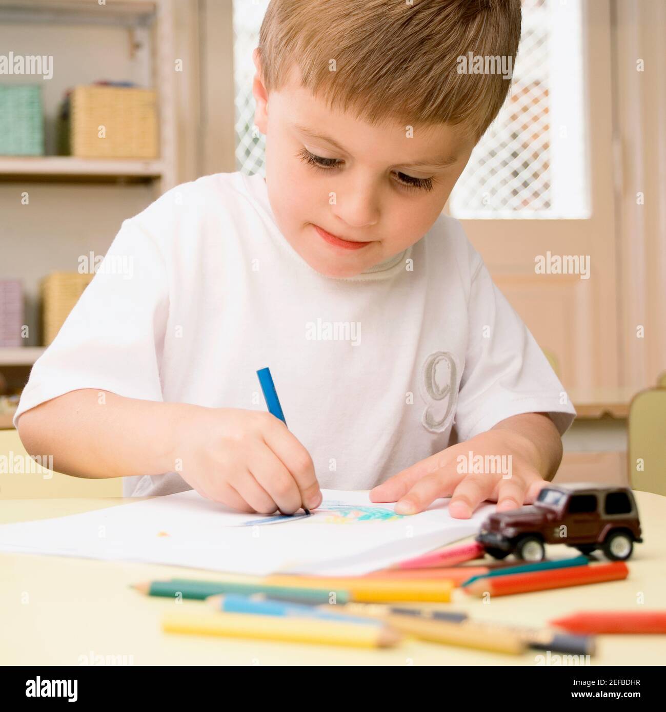 Close up of a boy drawing on a sheet of paper Stock Photo - Alamy