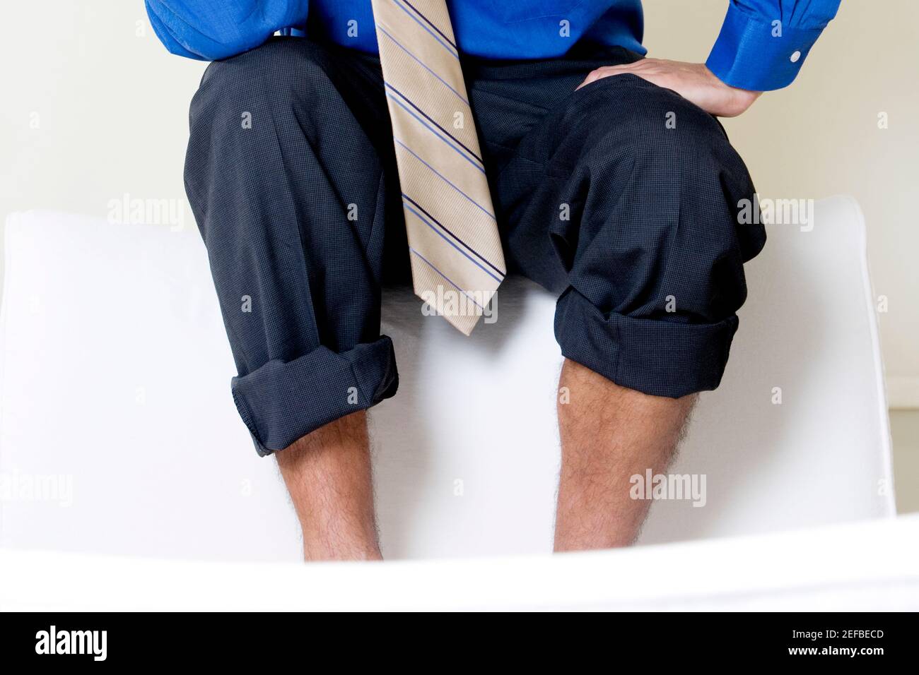 Mid section view of a businessman sitting on a couch Stock Photo - Alamy