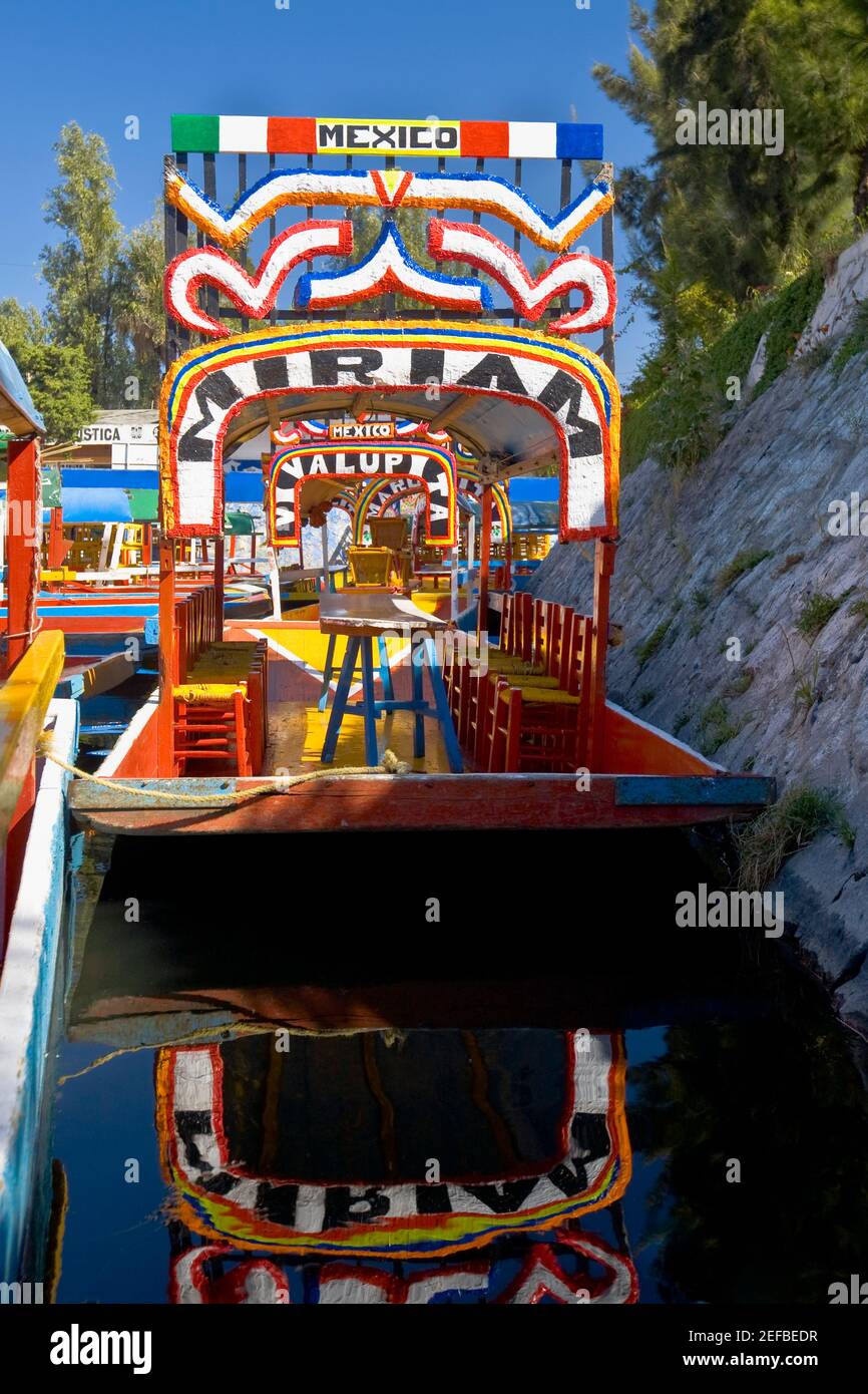 Reflection of a trajinerast boat in water, Xochimilco Gardens, Mexico ...