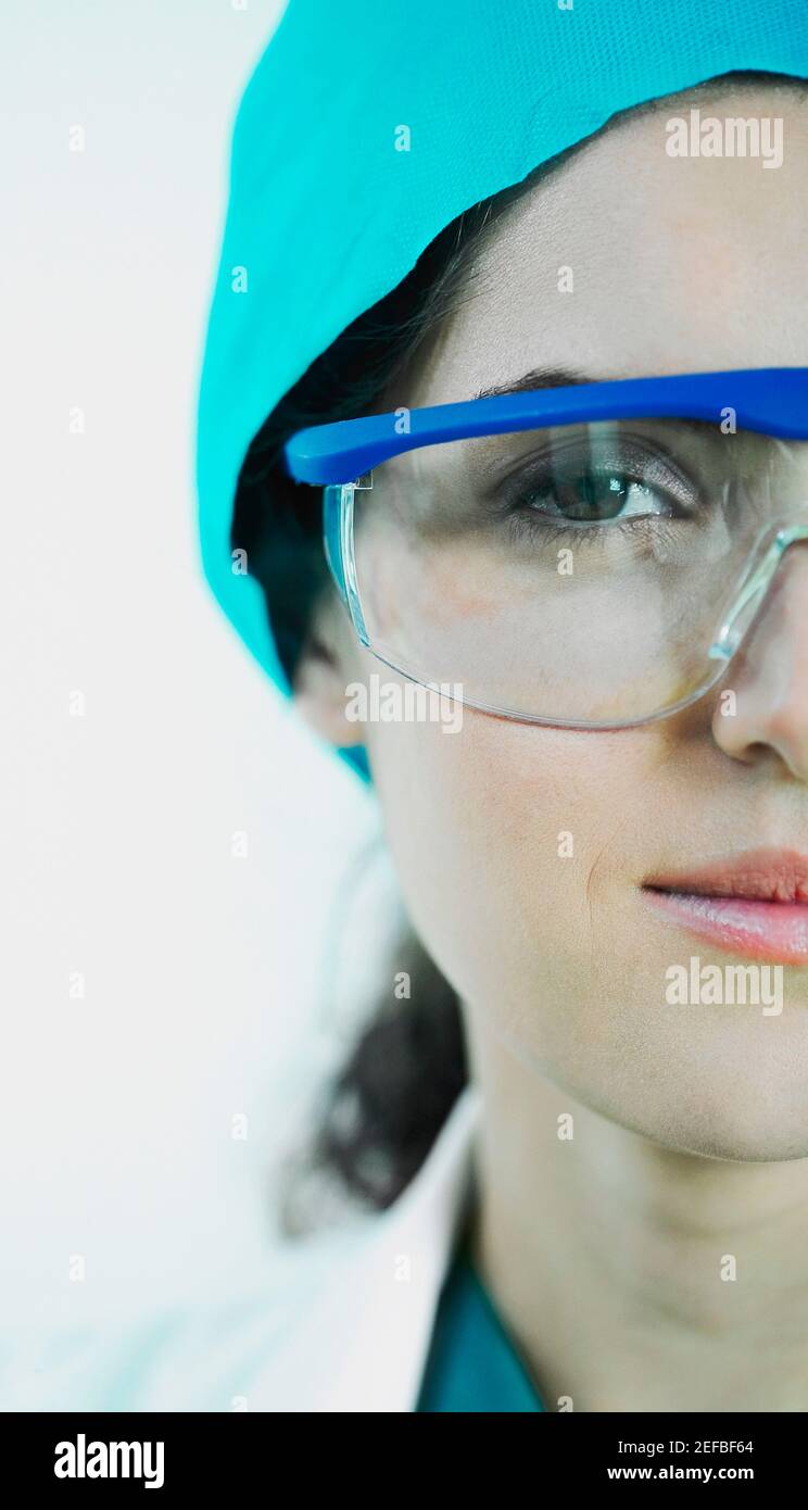 Portrait of a female doctor wearing a surgical cap and protective ...