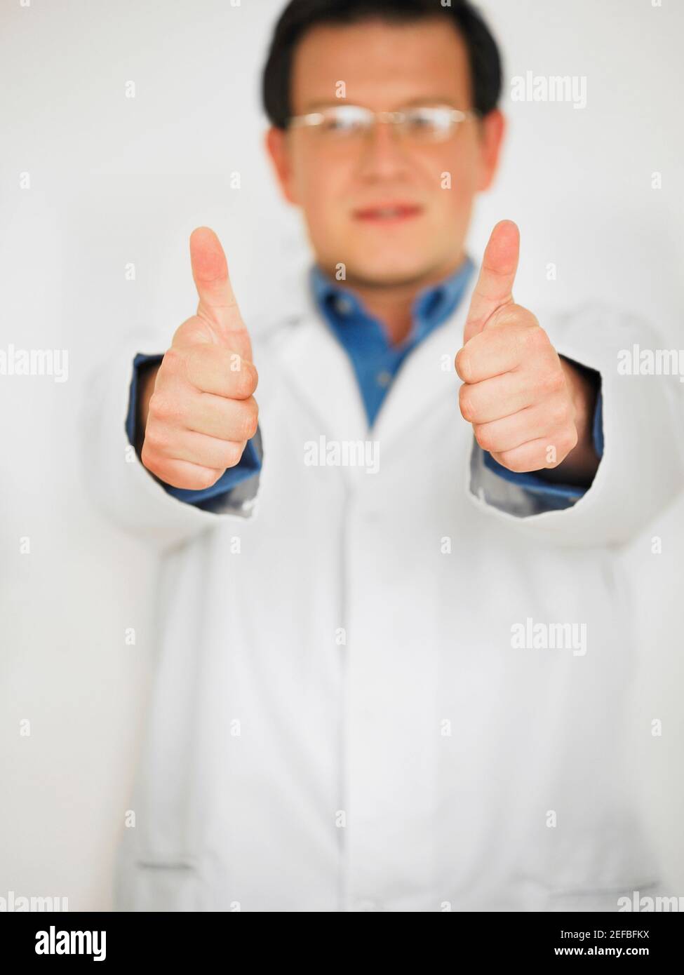 Close up of a male doctor showing a thumbs up sign Stock Photo - Alamy